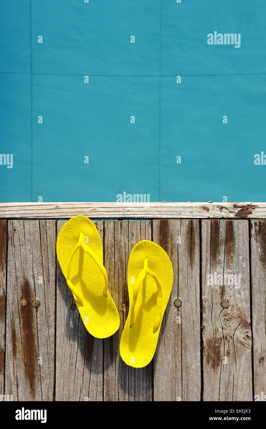 Sandals by a swimming pool Stock Photo - Alamy