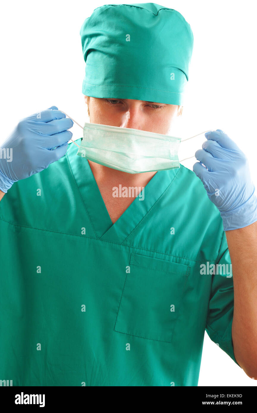 Pulling on surgical mask Stock Photo - Alamy