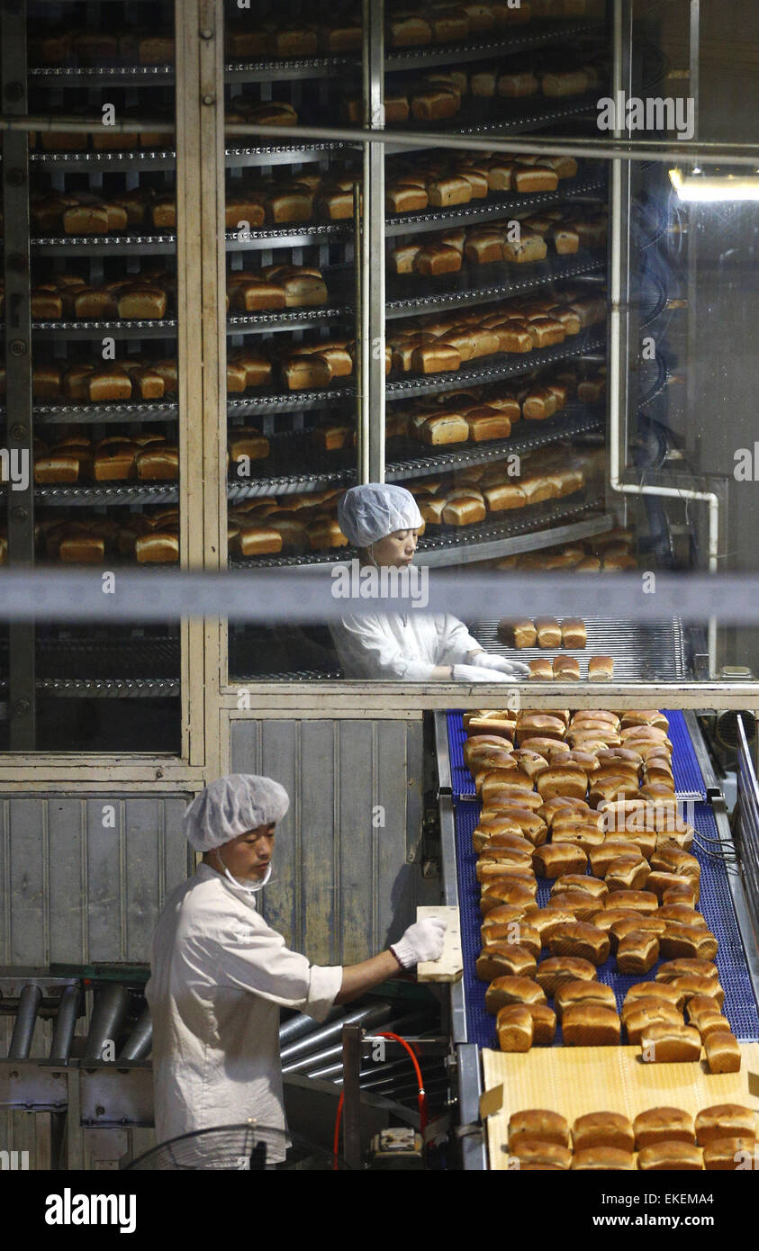 Beijing, China. 9th Apr, 2015. A staff member works on a bread ...