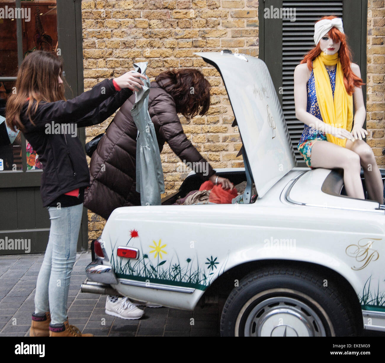 Ladies looking at clothes out of a car boot Stock Photo - Alamy