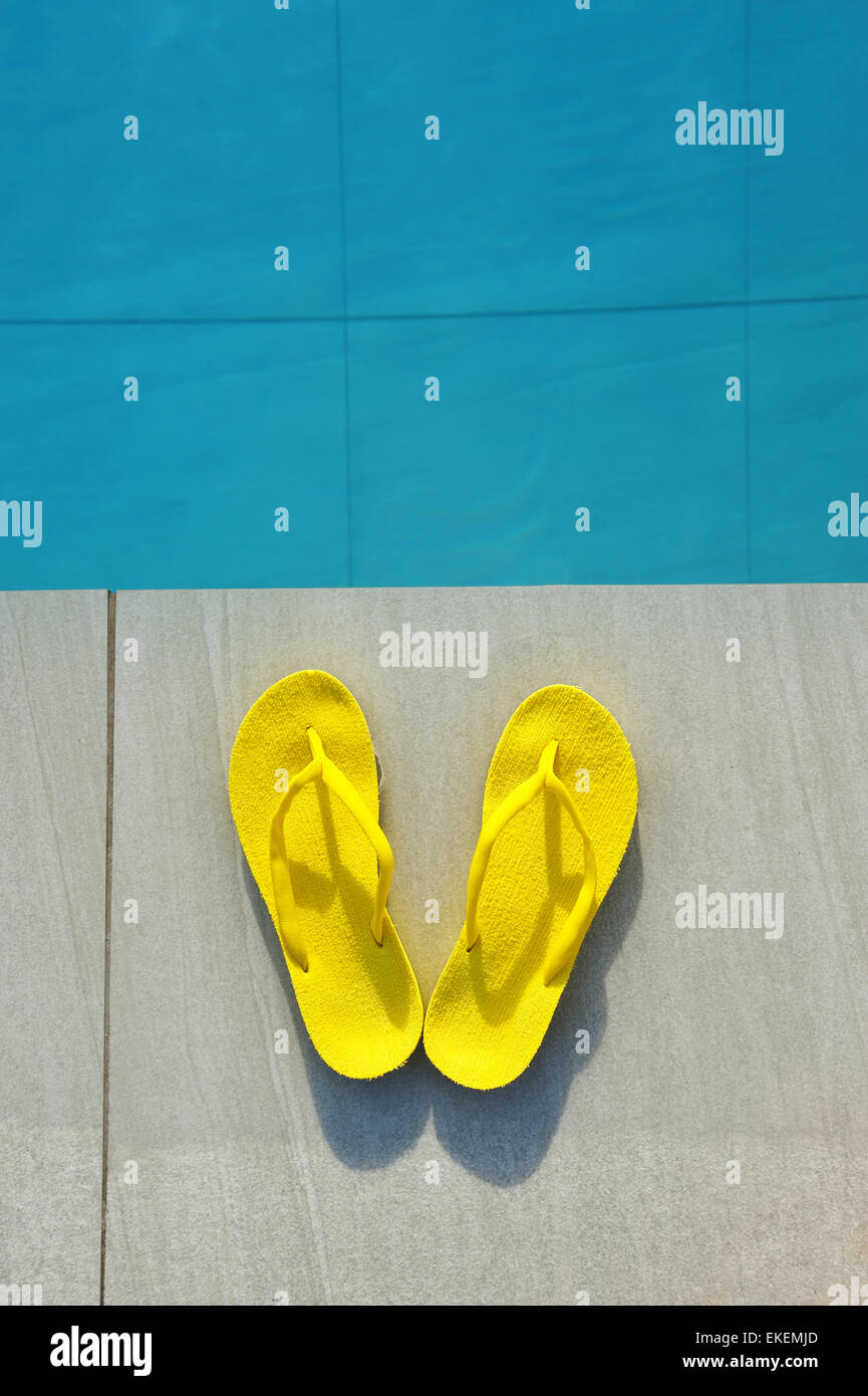 Sandals by a swimming pool Stock Photo - Alamy