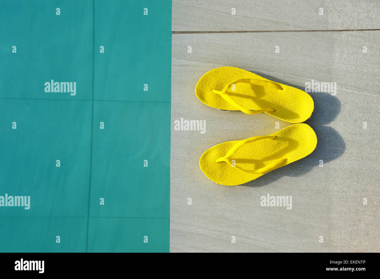Sandals by a swimming pool Stock Photo - Alamy