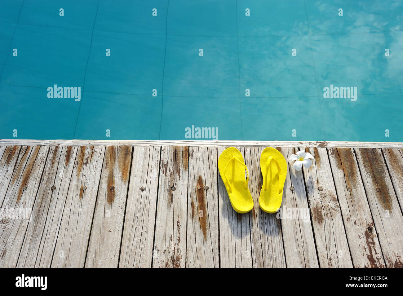 Sandals by a swimming pool Stock Photo - Alamy
