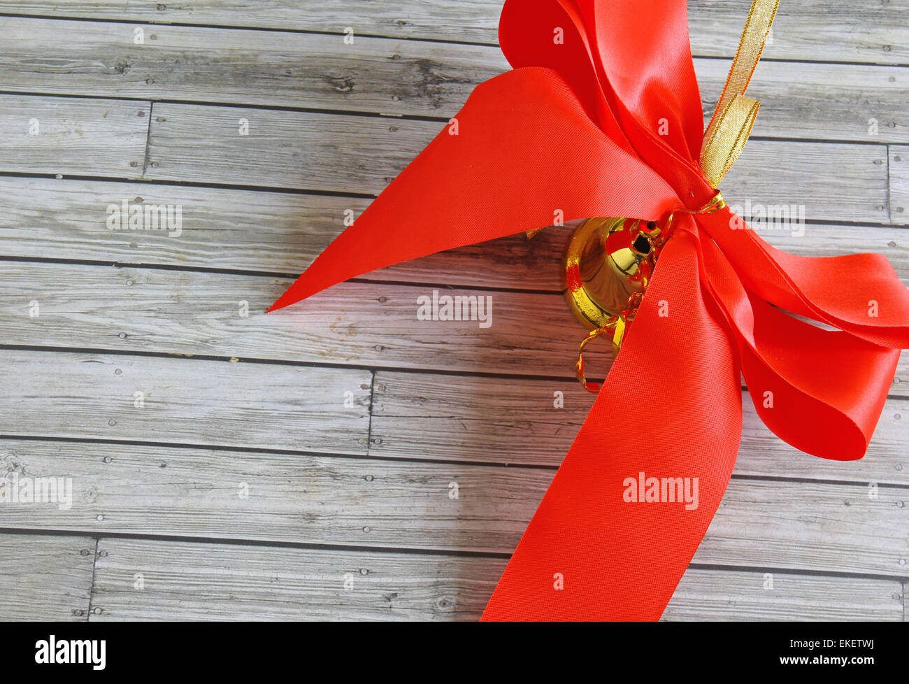 Bell with red ribbon over wooden background Stock Photo - Alamy