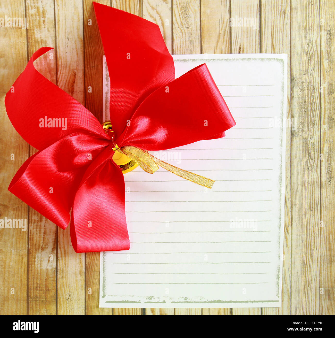 Red ribbon with blank notebook over wooden background Stock Photo - Alamy