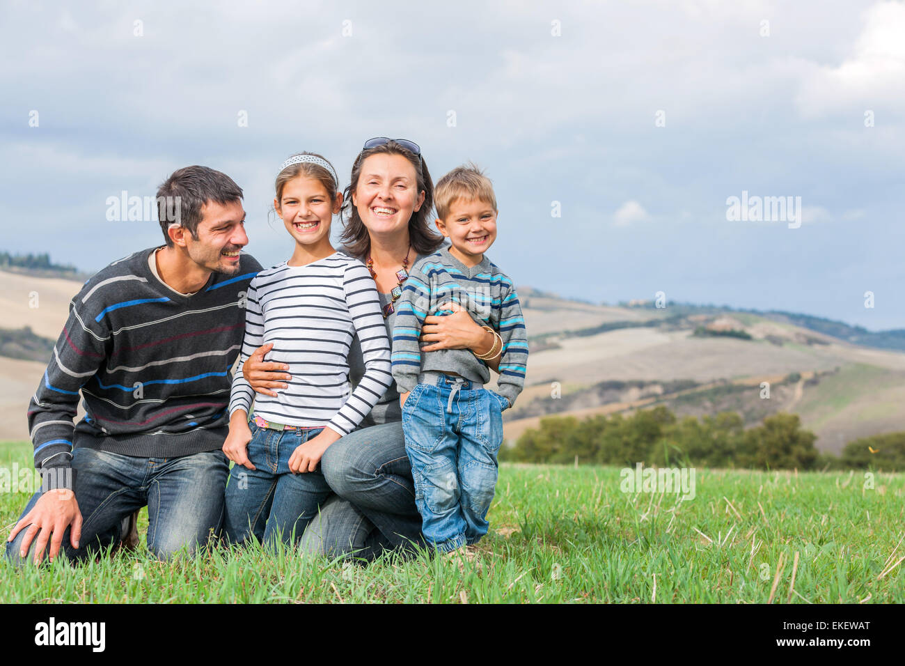 Happy family having fun outdoors in Tuscan Stock Photo - Alamy