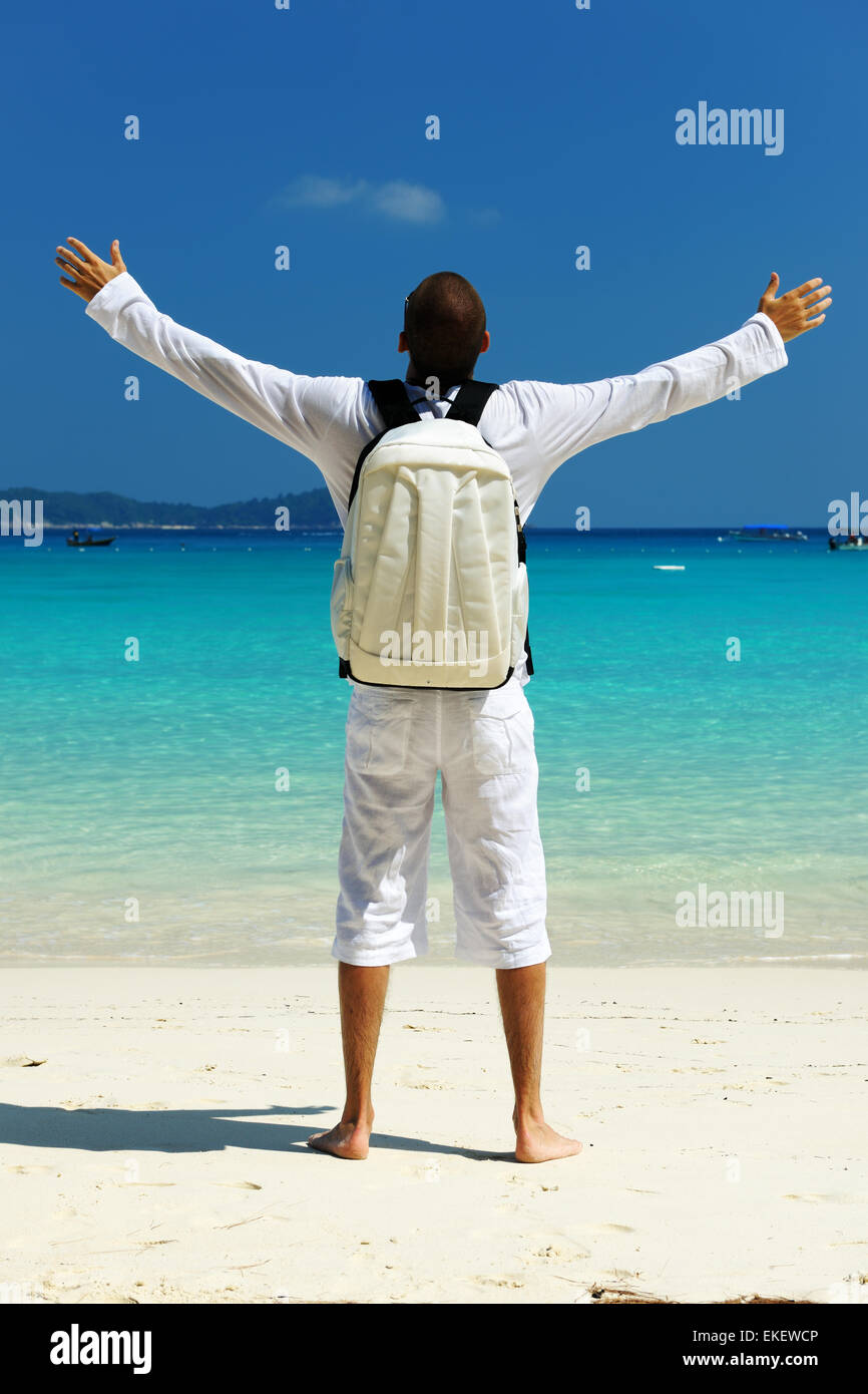 Man with backpack at beach Stock Photo - Alamy