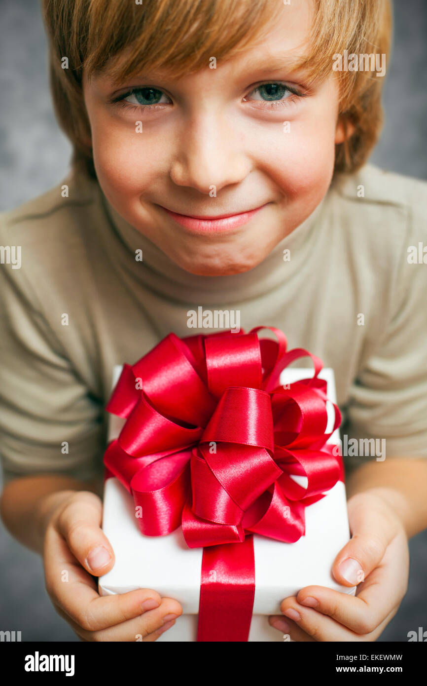 Boy holding present box Stock Photo - Alamy