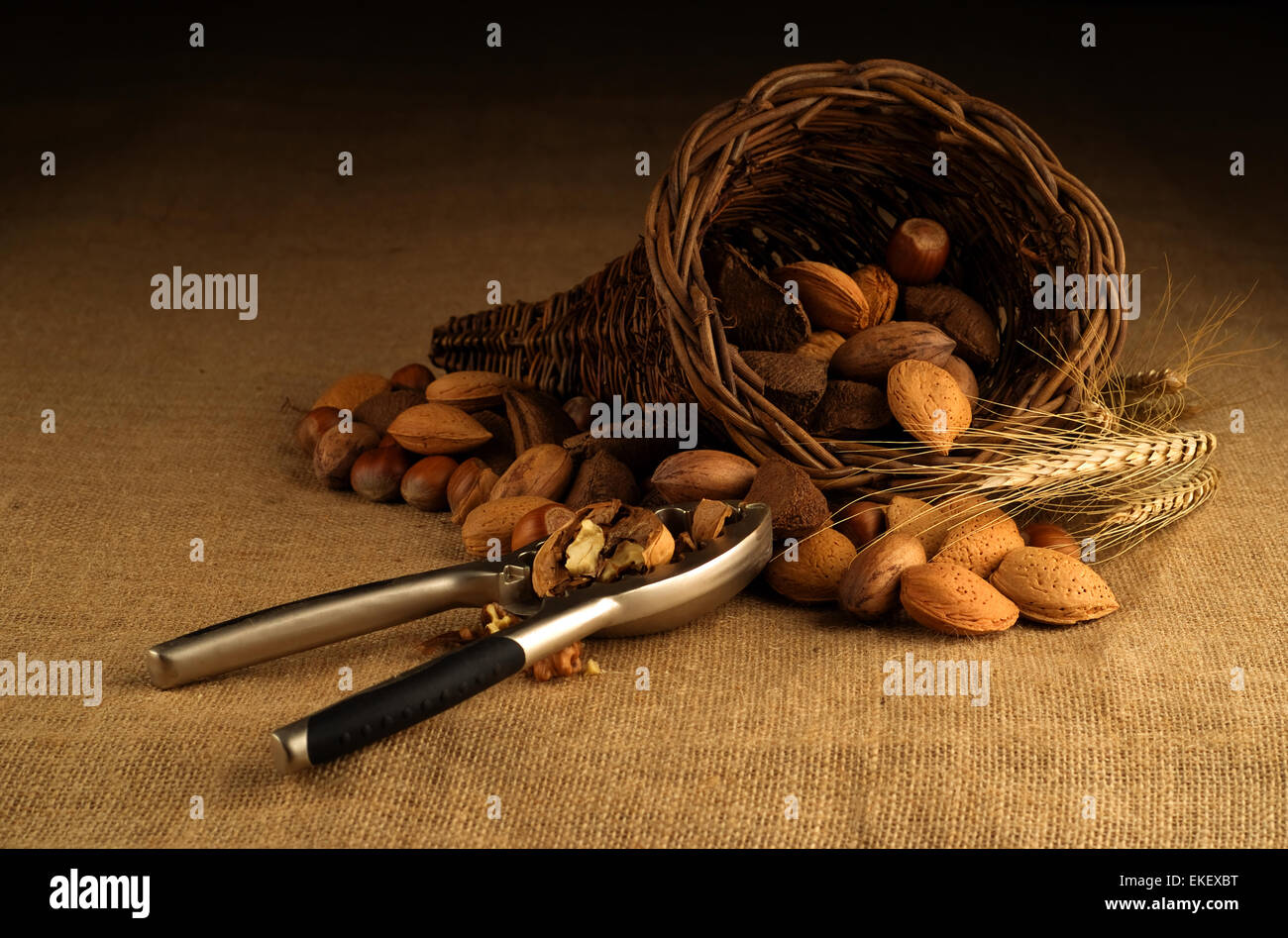 Assortment of nuts in basket with nutcracker Stock Photo - Alamy