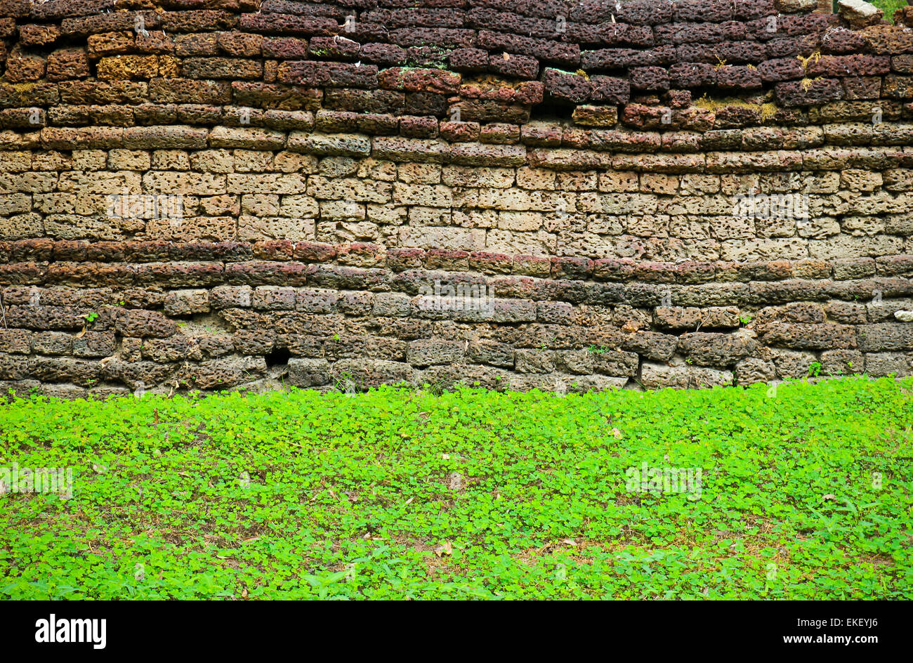 Texture of rough brick wall with grass Stock Photo - Alamy