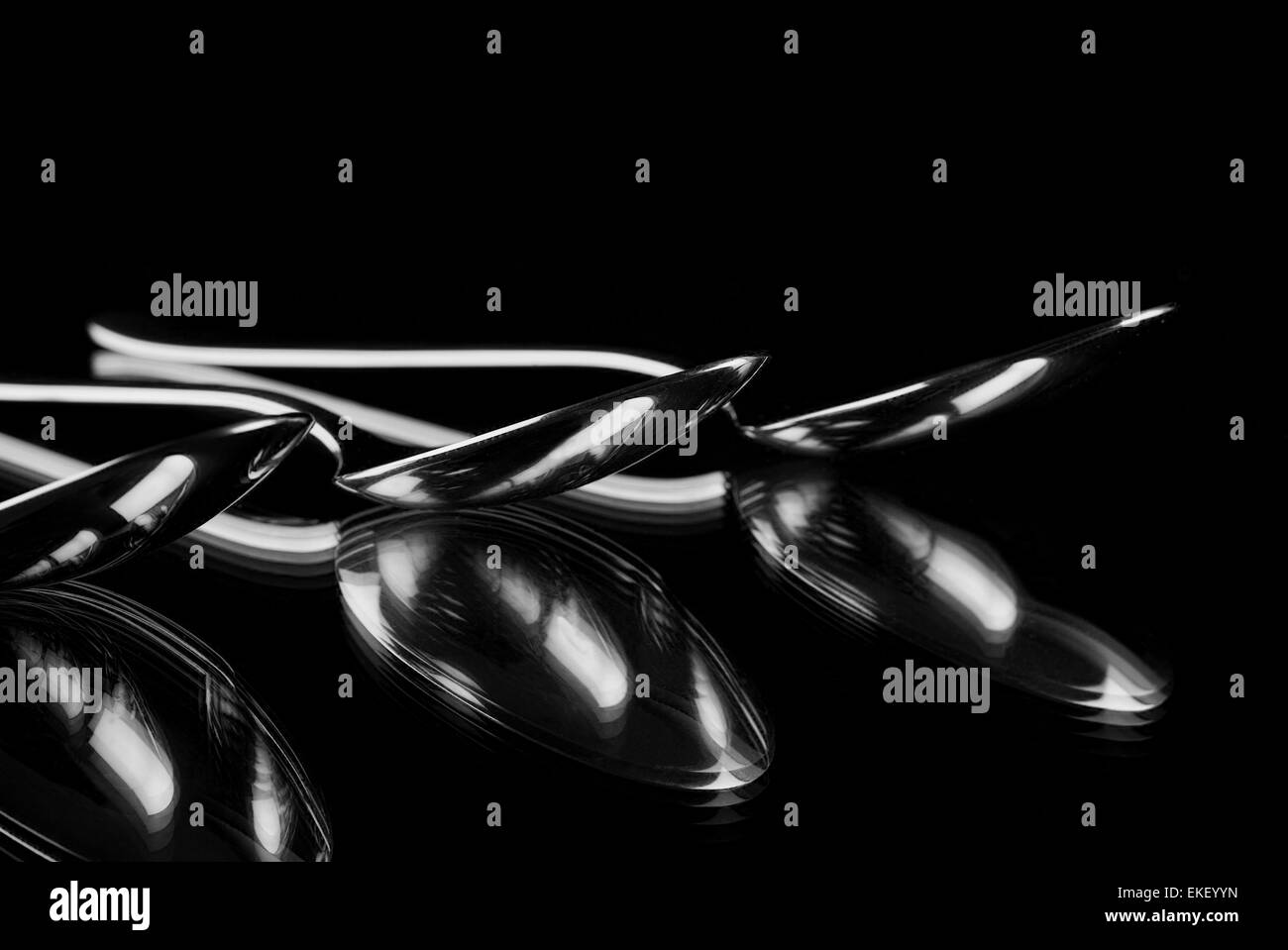 Spoons reflecting in mirror Stock Photo - Alamy