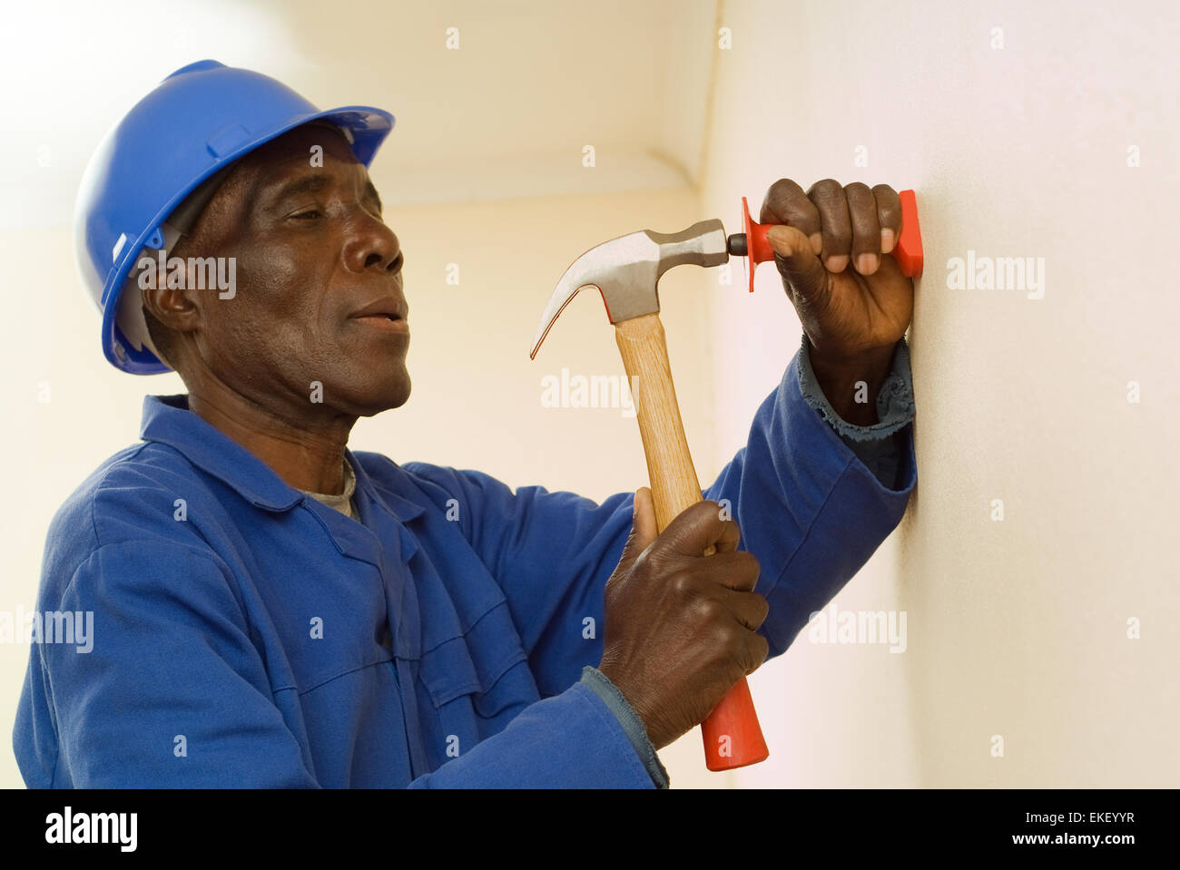 Construction Worker Holding Hammer Stock Photo - Alamy