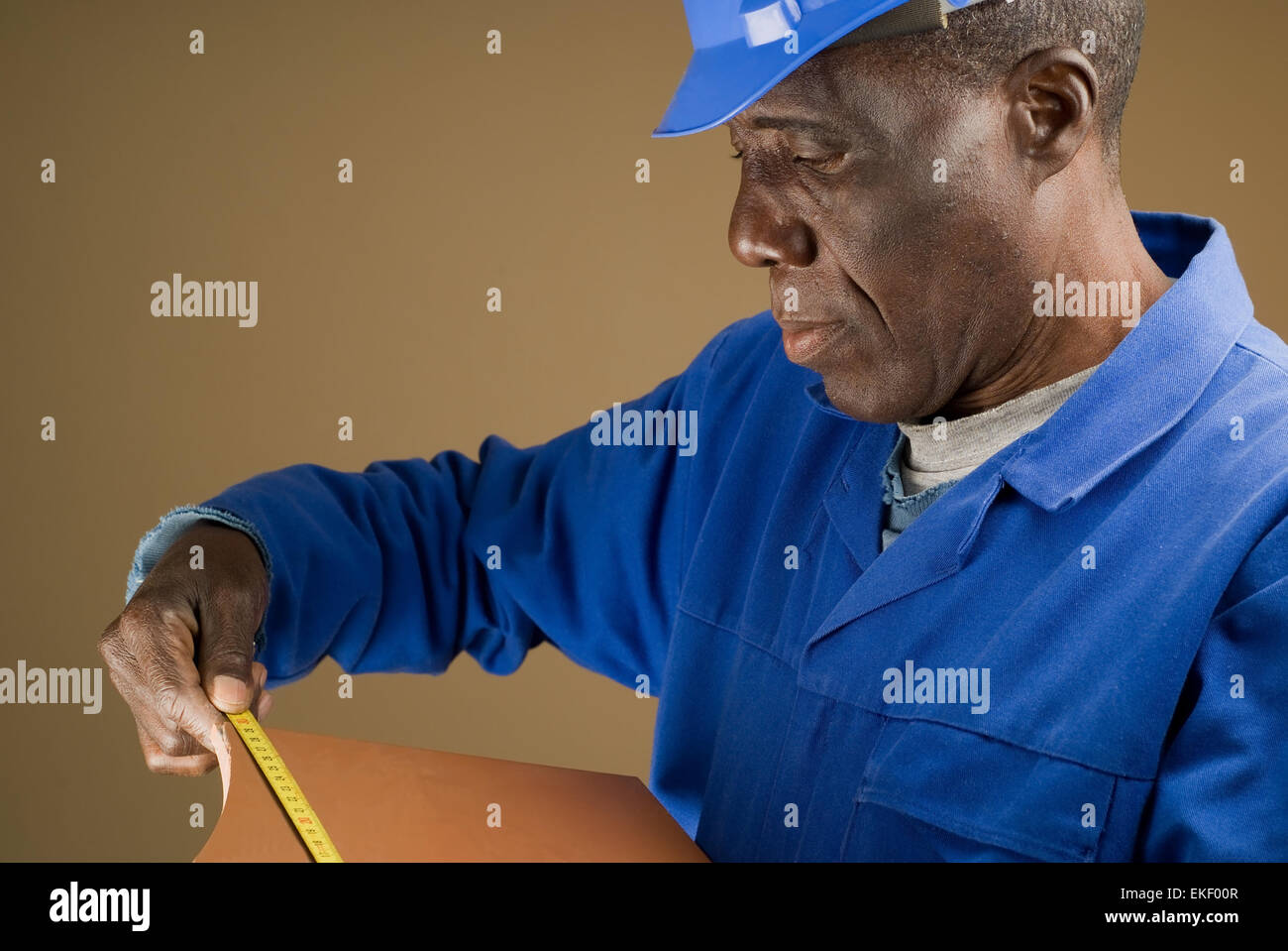 Construction Worker Measuring Tile Stock Photo - Alamy