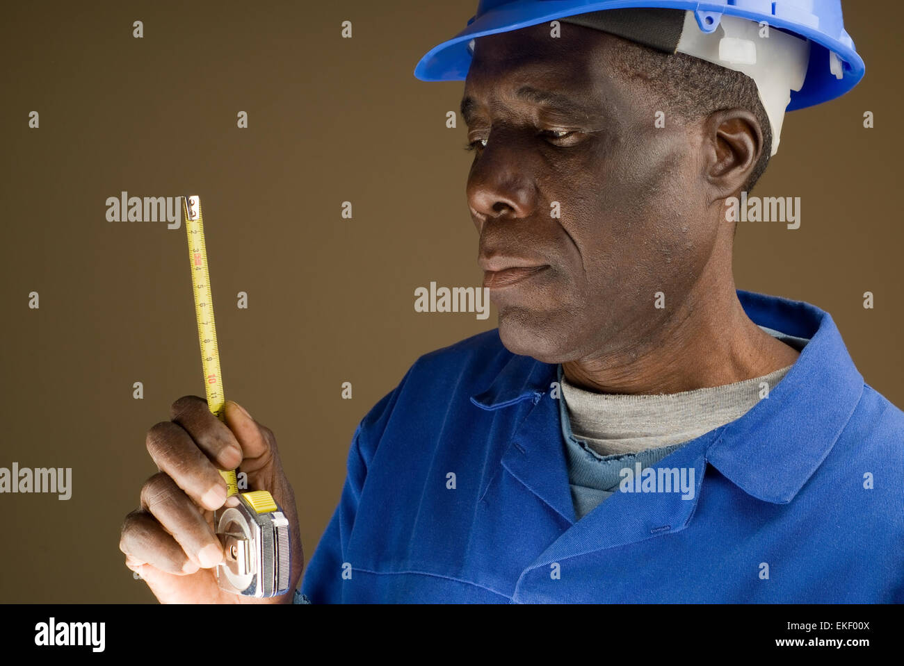 Construction Worker with Measuring Tool Stock Photo - Alamy