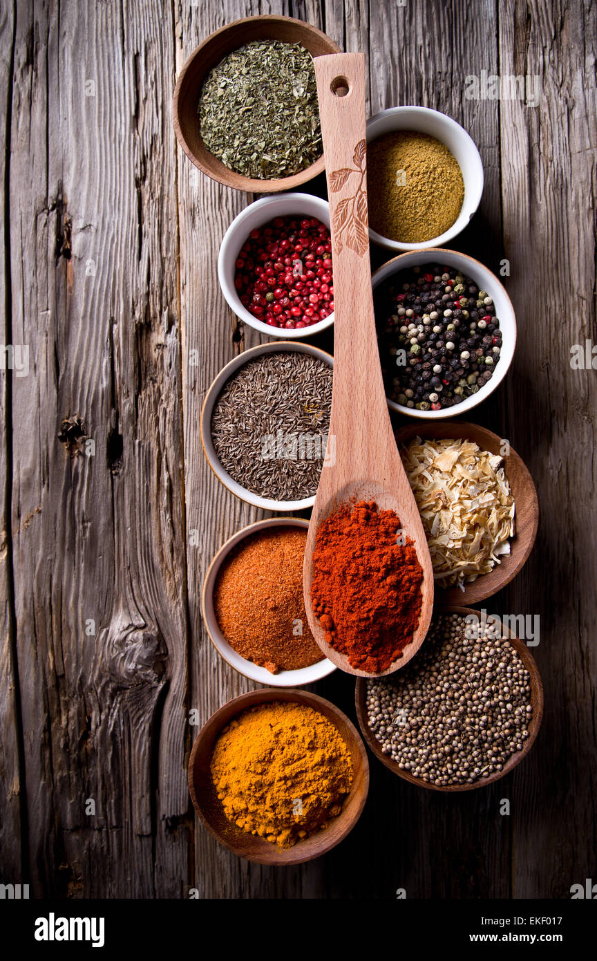 Assorted spices on wooden background Stock Photo - Alamy