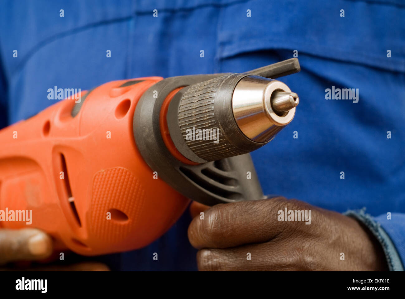 Construction worker holding a power tool Stock Photo - Alamy