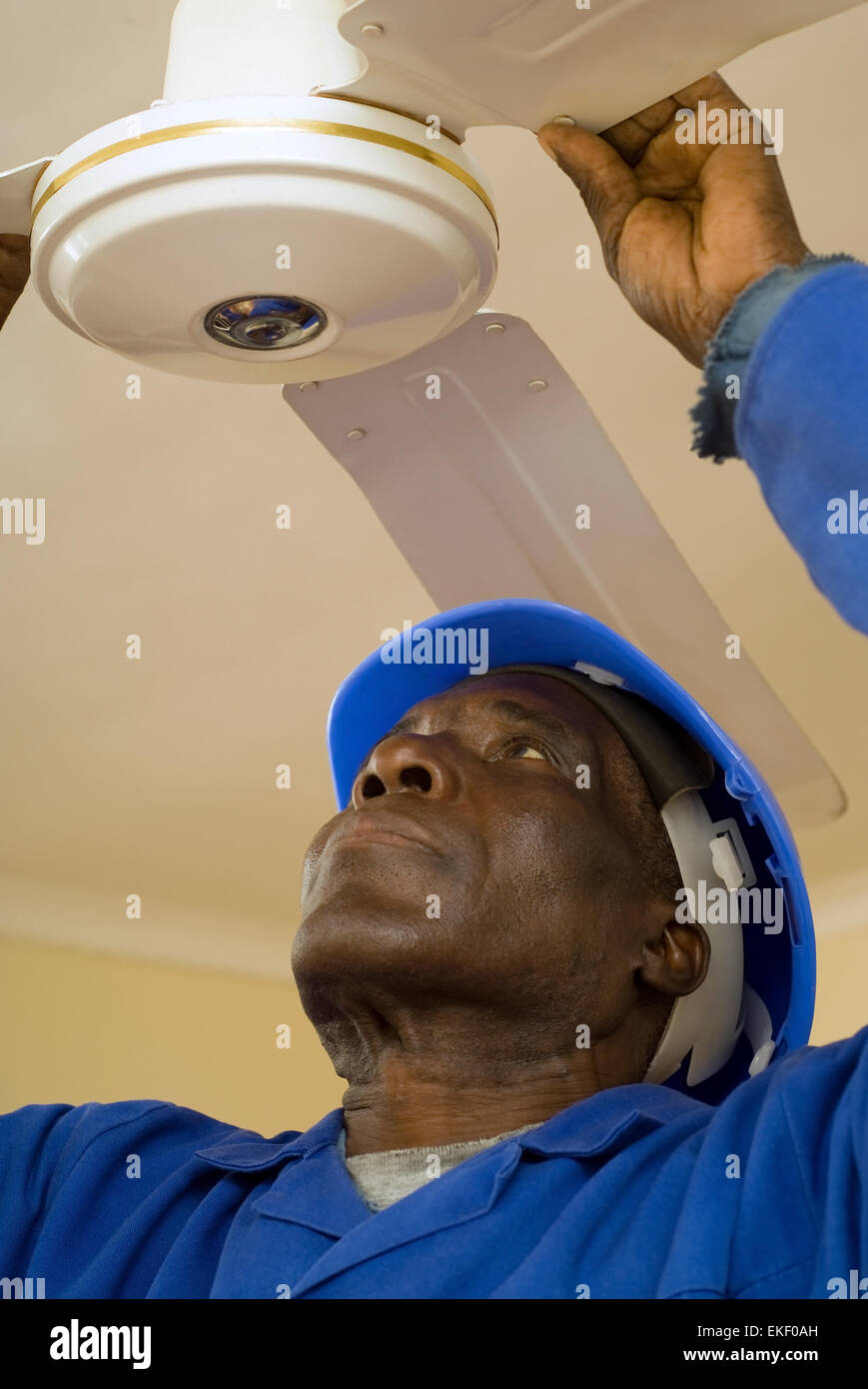 Construction Worker Fixing Ceiling Fan Stock Photo - Alamy