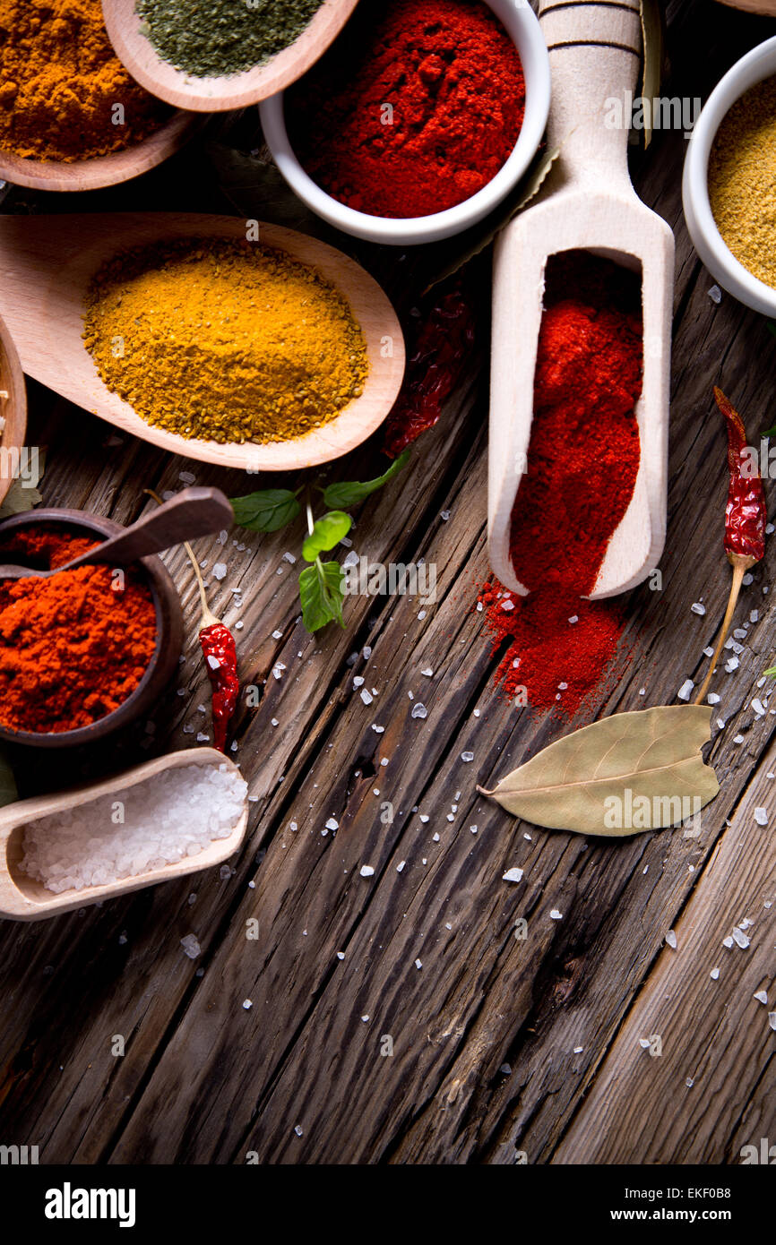 Assorted spices on wooden background Stock Photo - Alamy