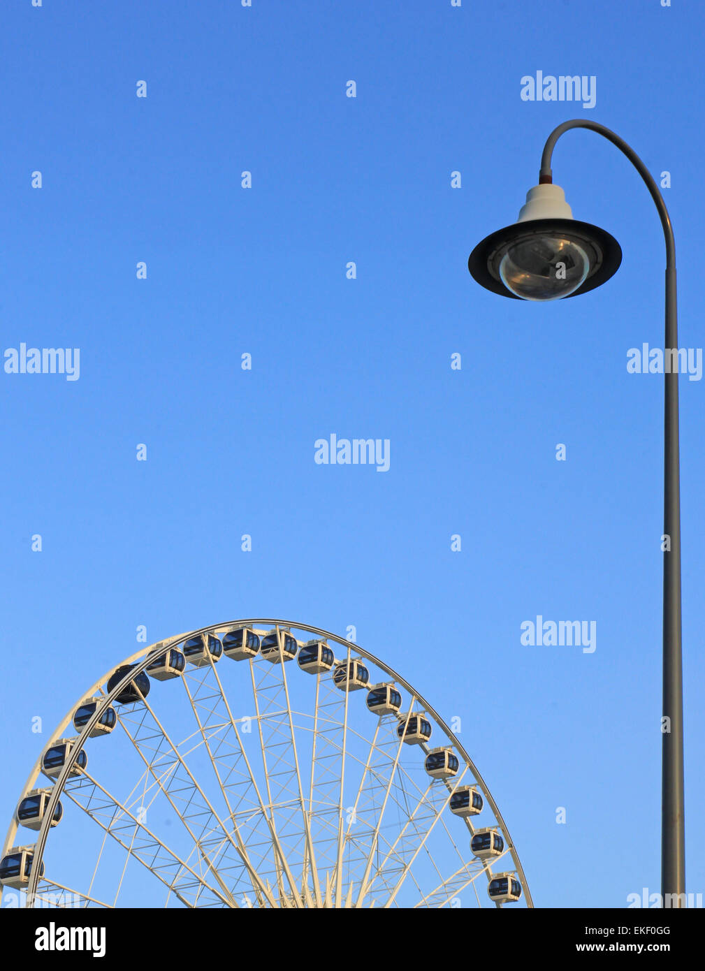 Street light with ferris wheel on blue sky Stock Photo - Alamy