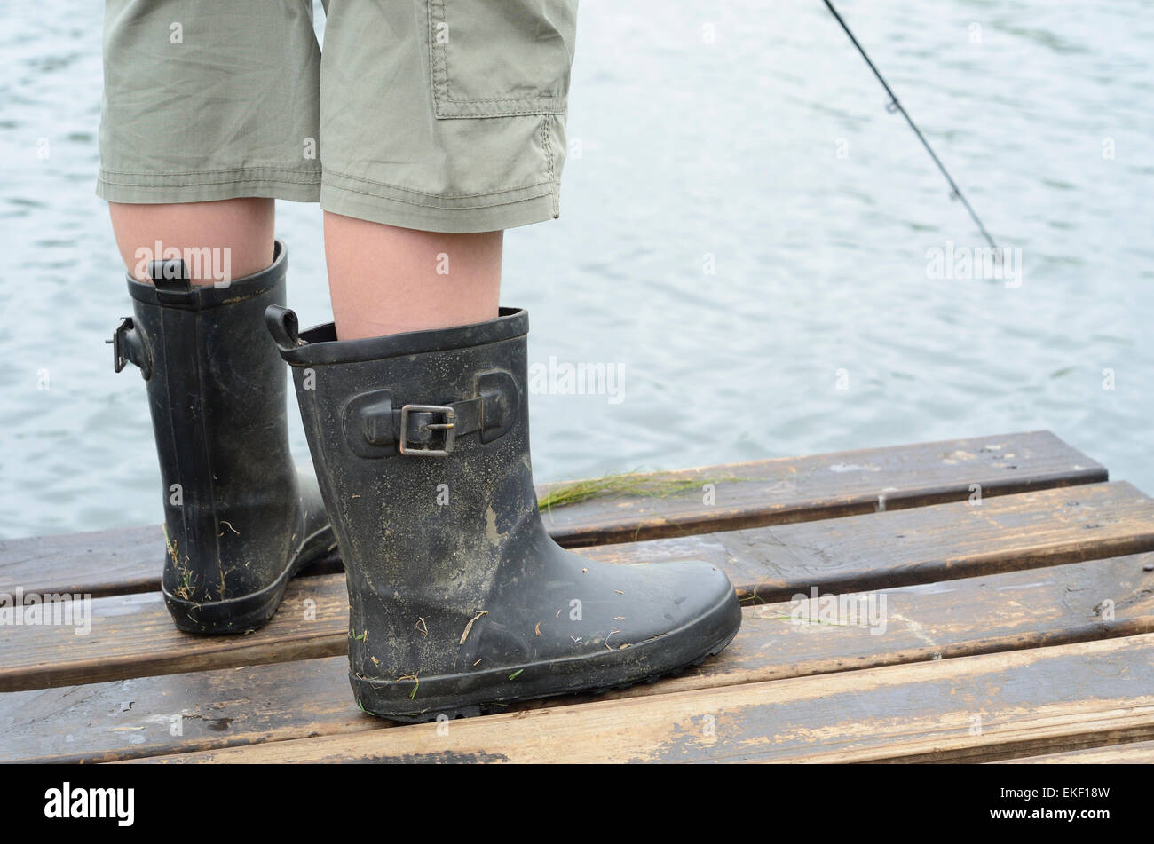 Fishing rod and boots Stock Photo - Alamy