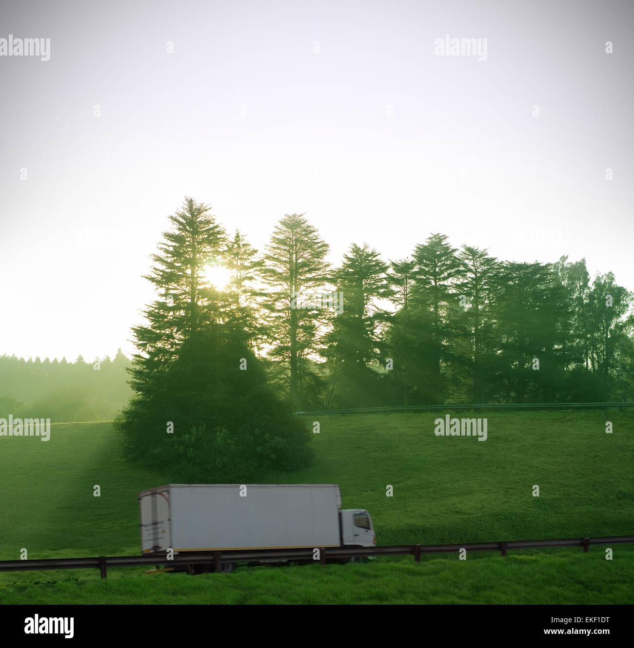 Truck delivery on freeway with trees Stock Photo - Alamy