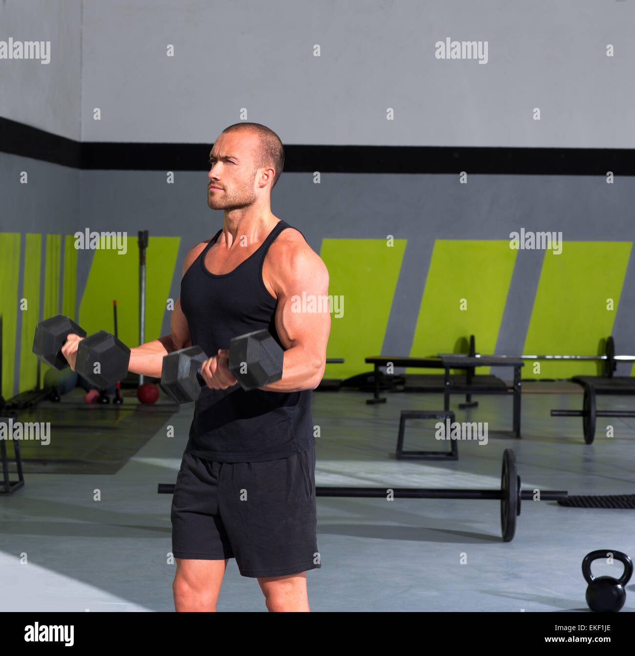Gym man with dumbbells exercise crossfit Stock Photo - Alamy