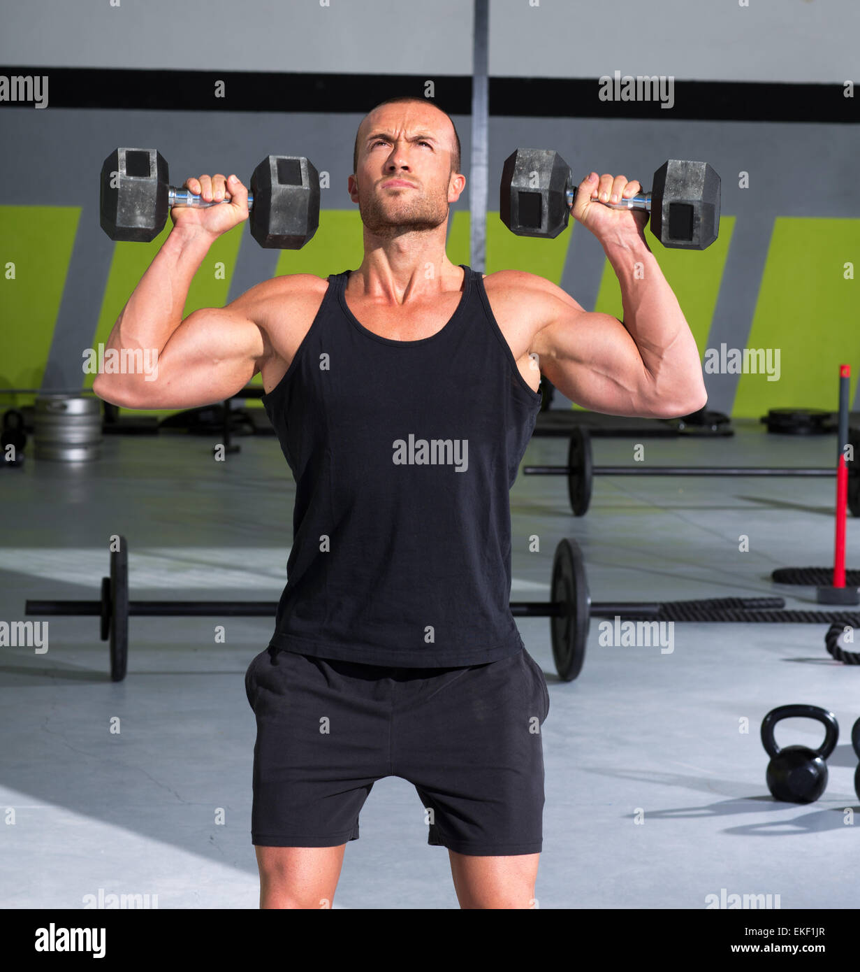Gym man with dumbbells exercise crossfit Stock Photo - Alamy