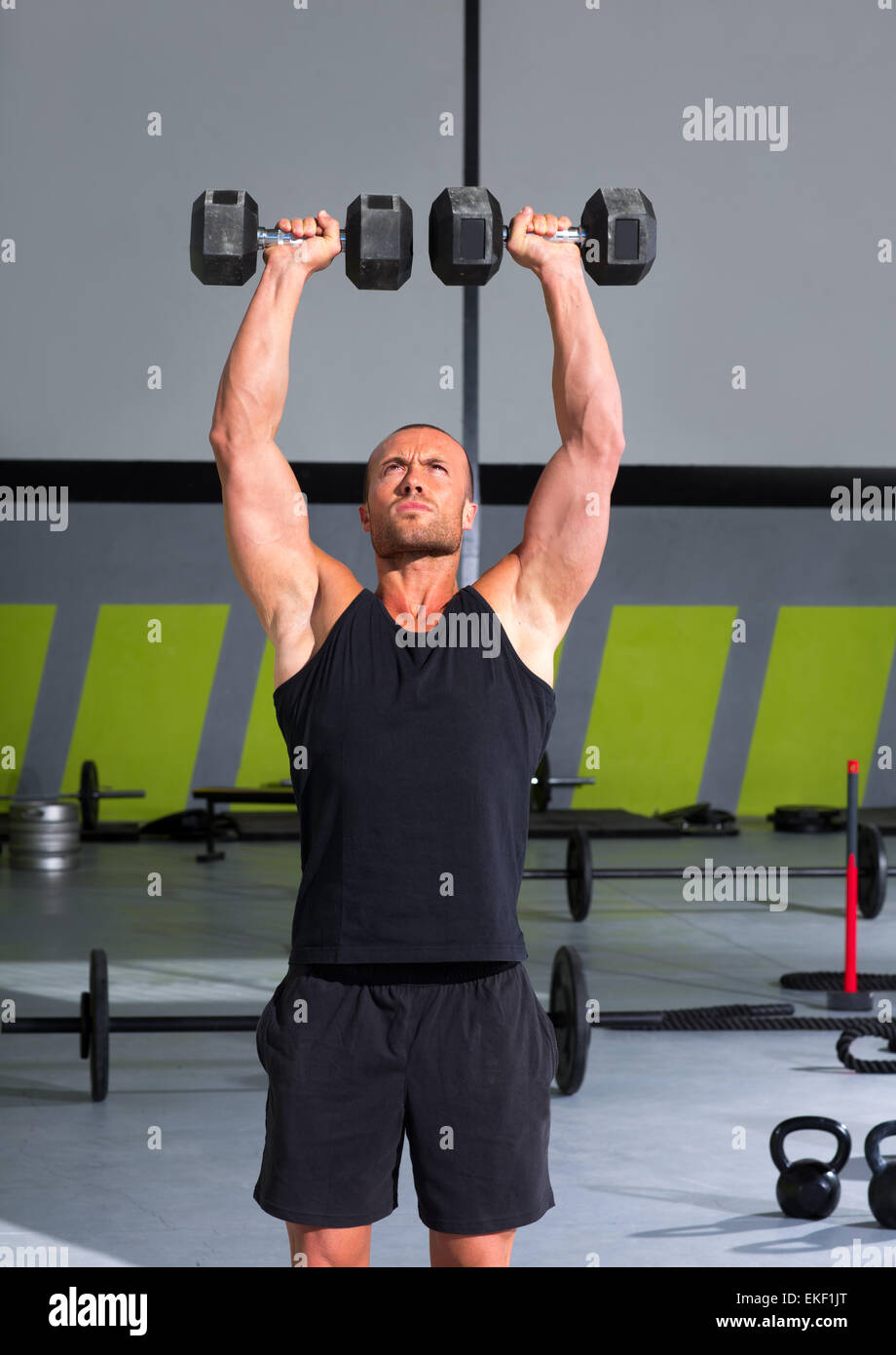 Gym man with dumbbells exercise crossfit Stock Photo - Alamy