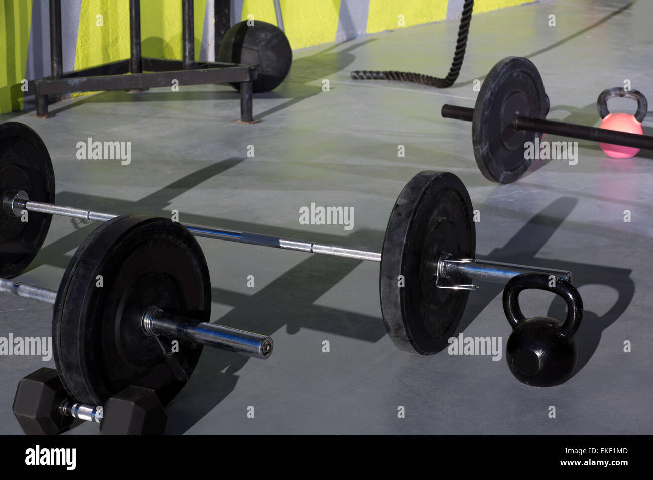 Kettlebells at crossfit gym with lifting bar weights Stock Photo - Alamy