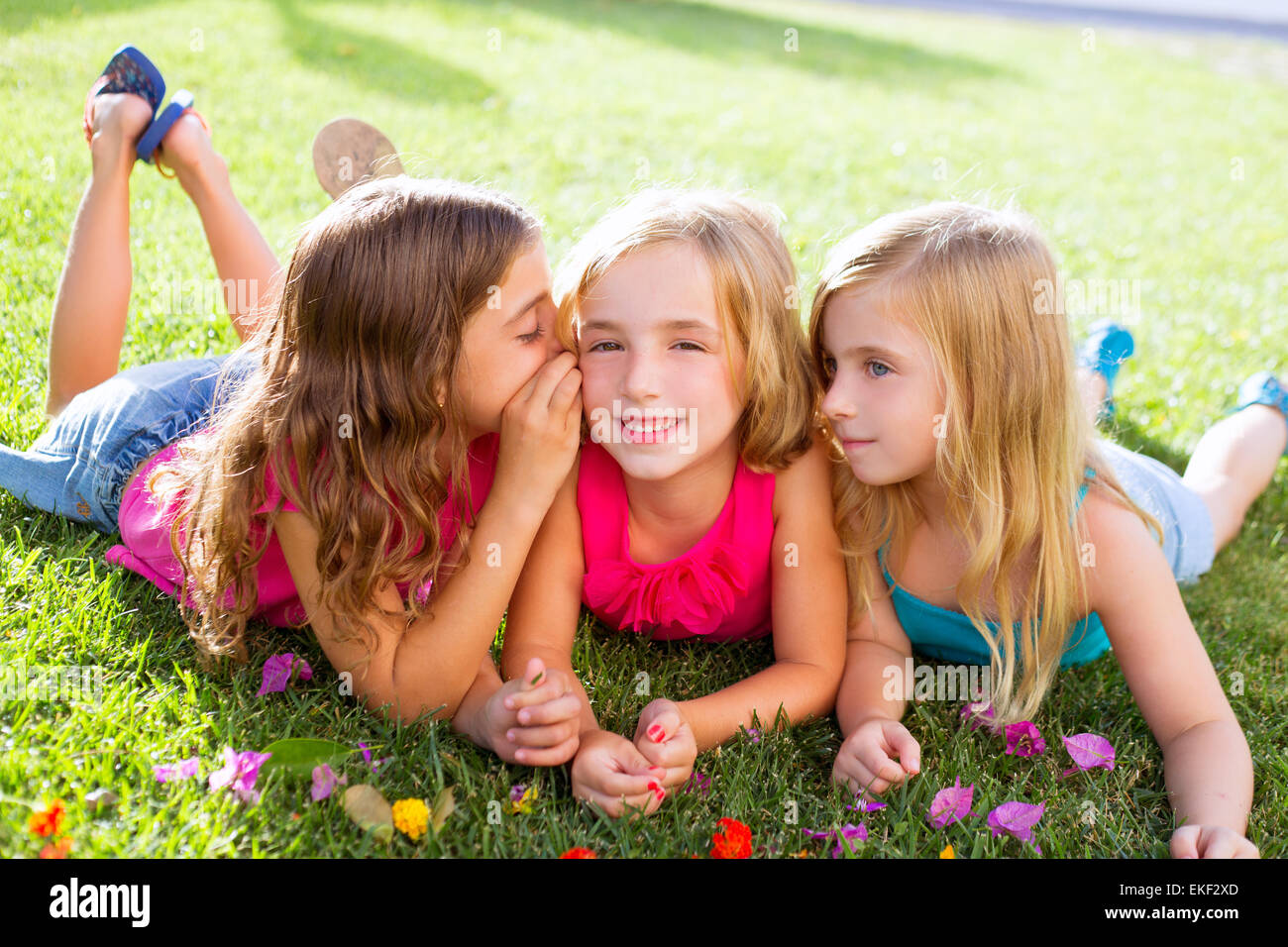 children girls playing whispering on flowers grass Stock Photo - Alamy
