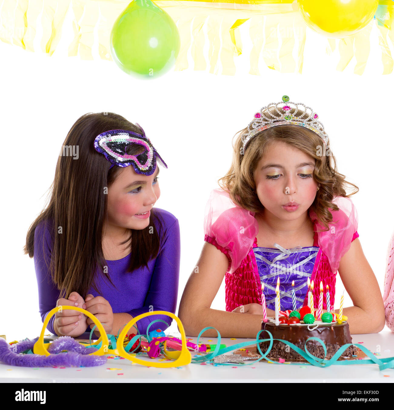 children happy girls blowing birthday party cake Stock Photo - Alamy