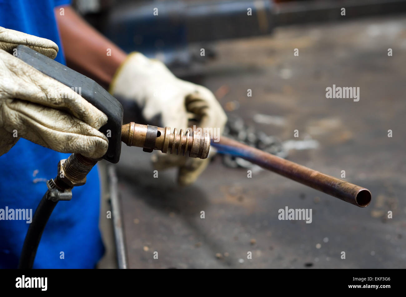 Welder worker heating copper pipe Stock Photo - Alamy
