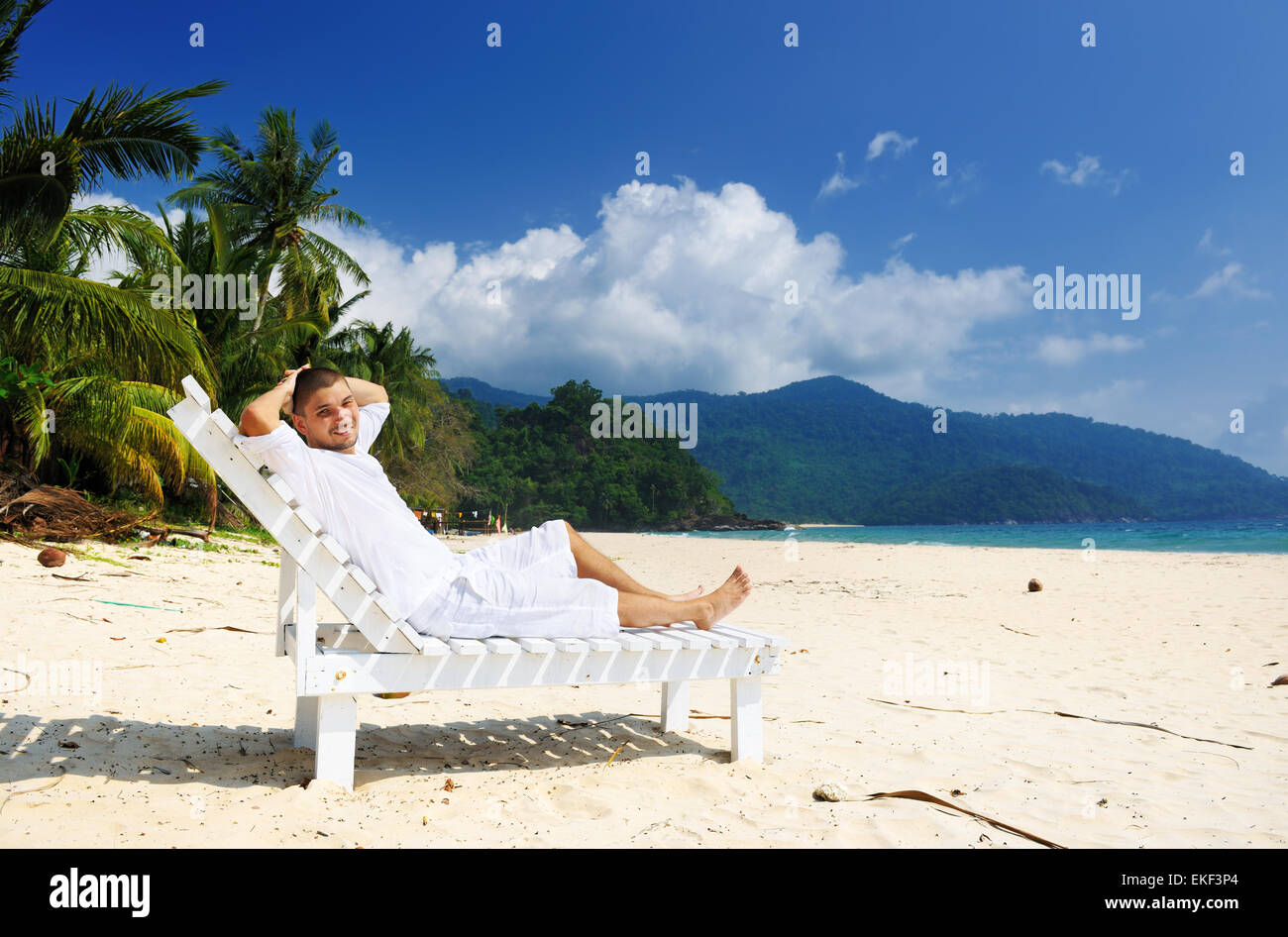 Man relaxing on a beach Stock Photo - Alamy