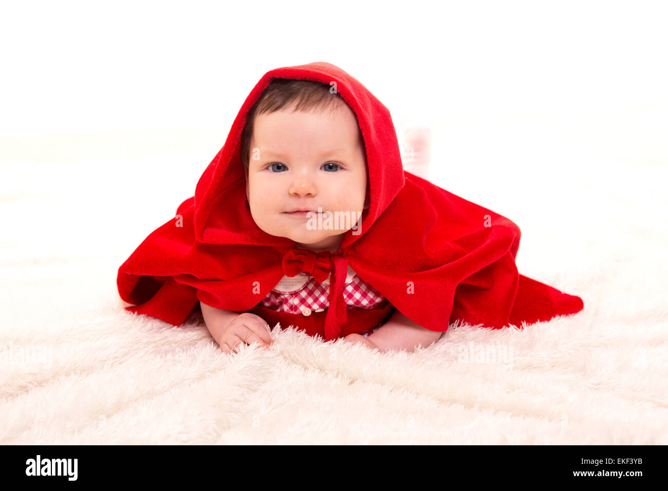 Baby Little Red Riding Hood on white fur Stock Photo - Alamy