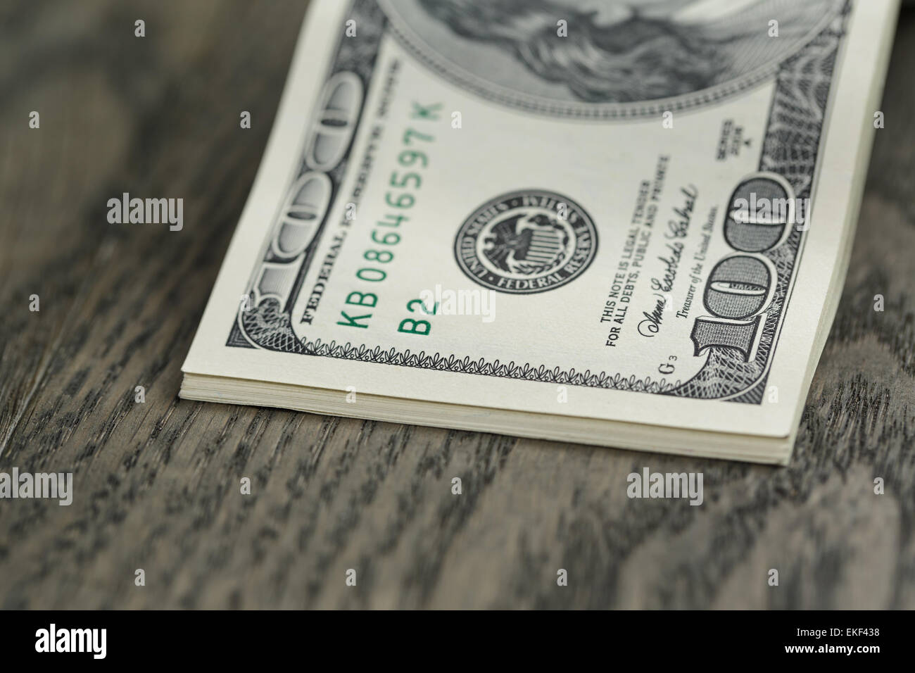hundred dollar bills on wood table Stock Photo - Alamy