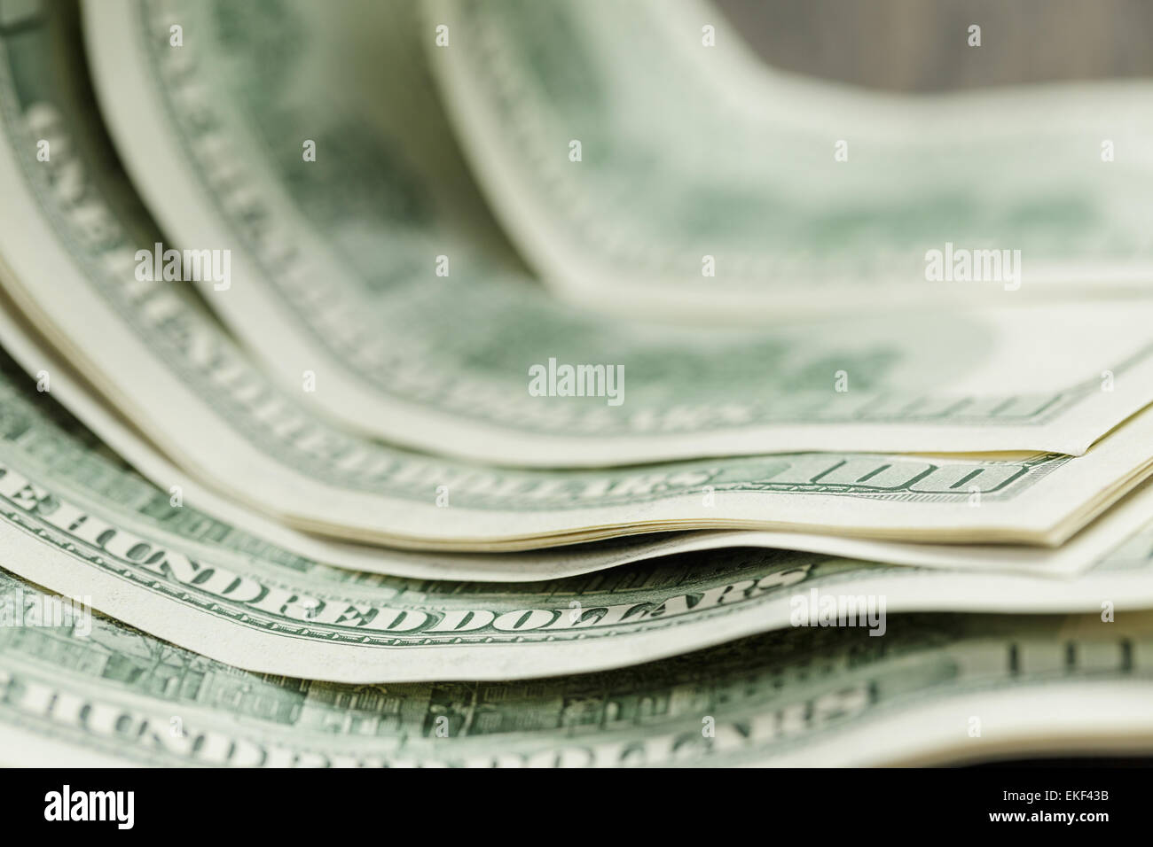 hundred dollar bills on wood table Stock Photo - Alamy