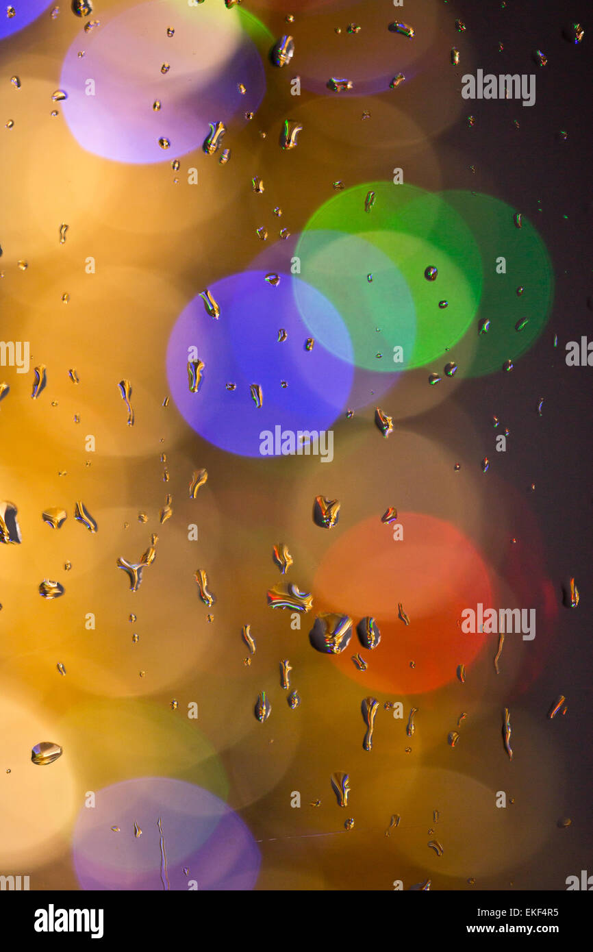 Drops of rain on window with bokeh lights abstract Stock Photo - Alamy