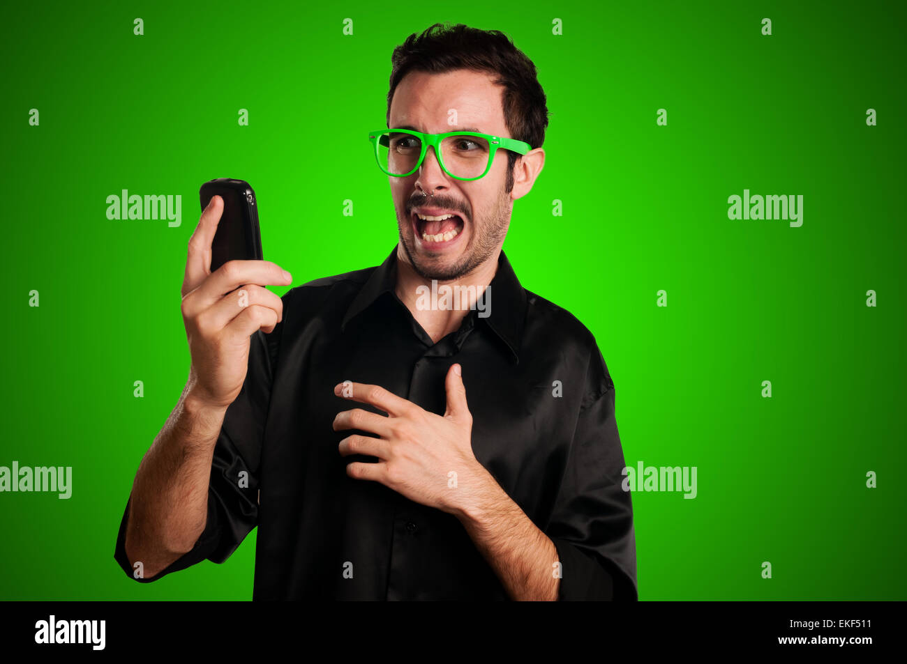 scared man holding phone Stock Photo - Alamy