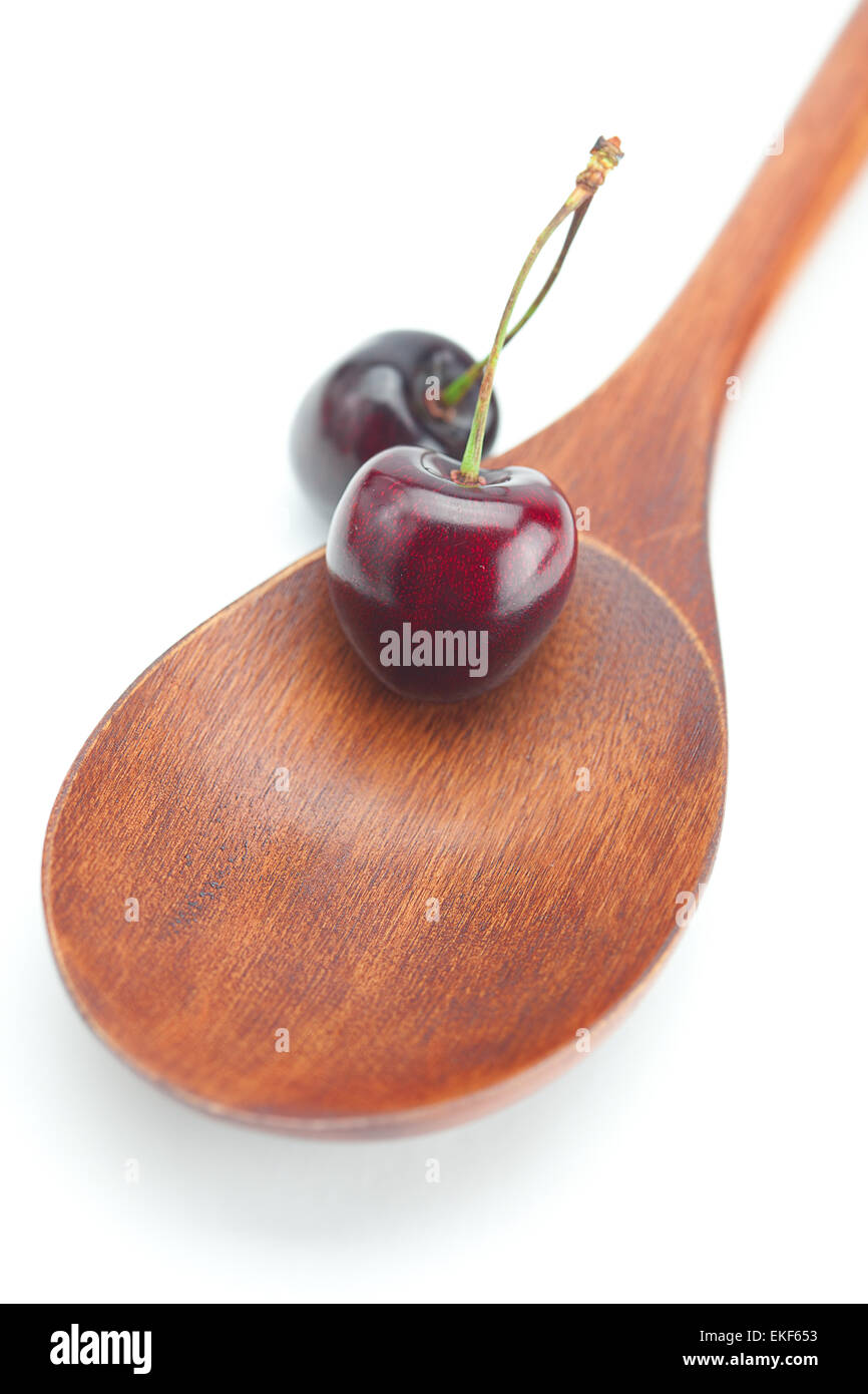 wooden spoon and cherry isolated on white Stock Photo - Alamy
