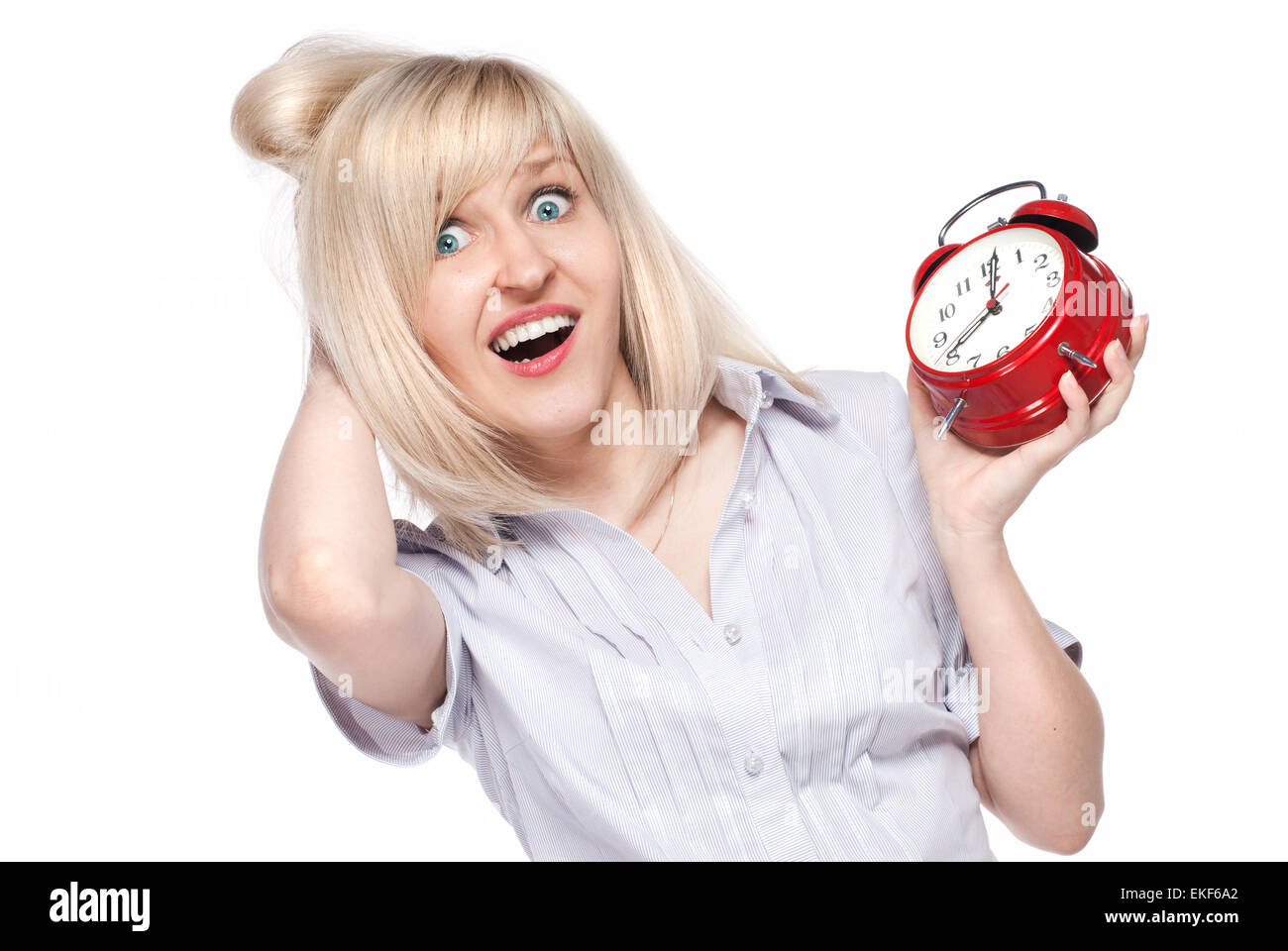 Shocked beautiful young woman with alarm clock isolated on white Stock ...
