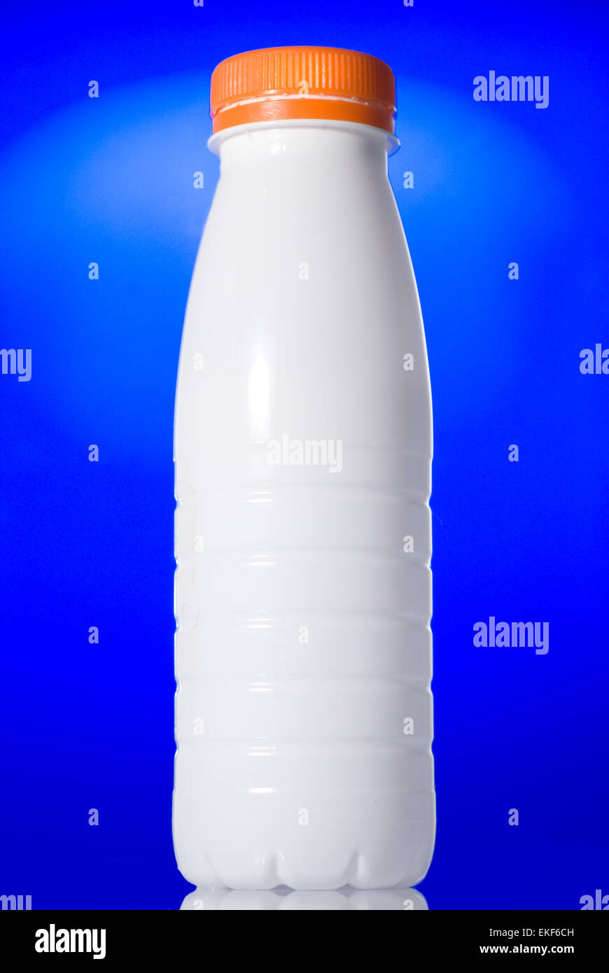 White milk bottle isolated on blue Stock Photo - Alamy