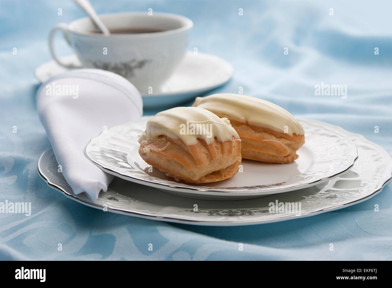 Eclairs with tea Stock Photo - Alamy