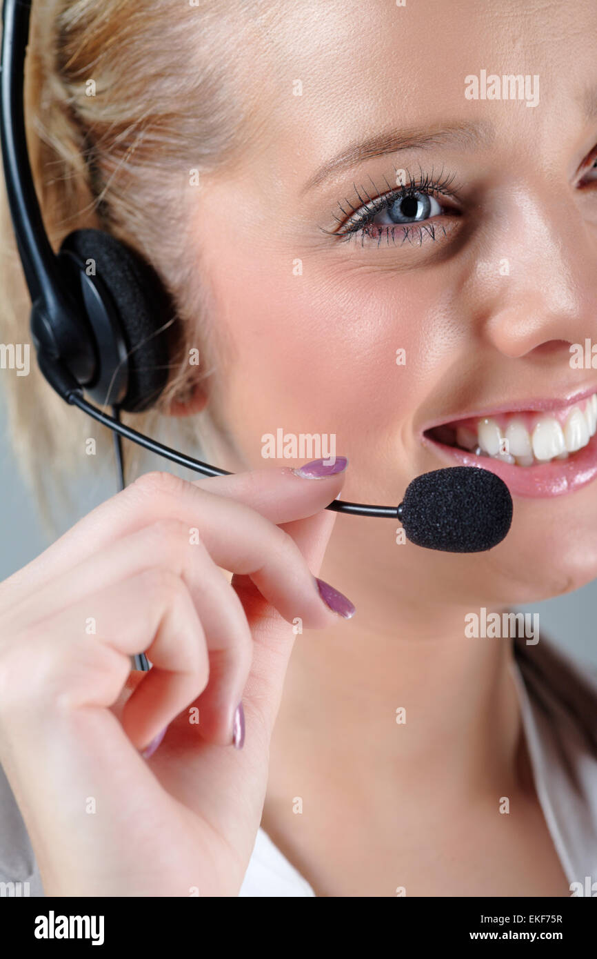 Woman wearing a headset at work Stock Photo - Alamy