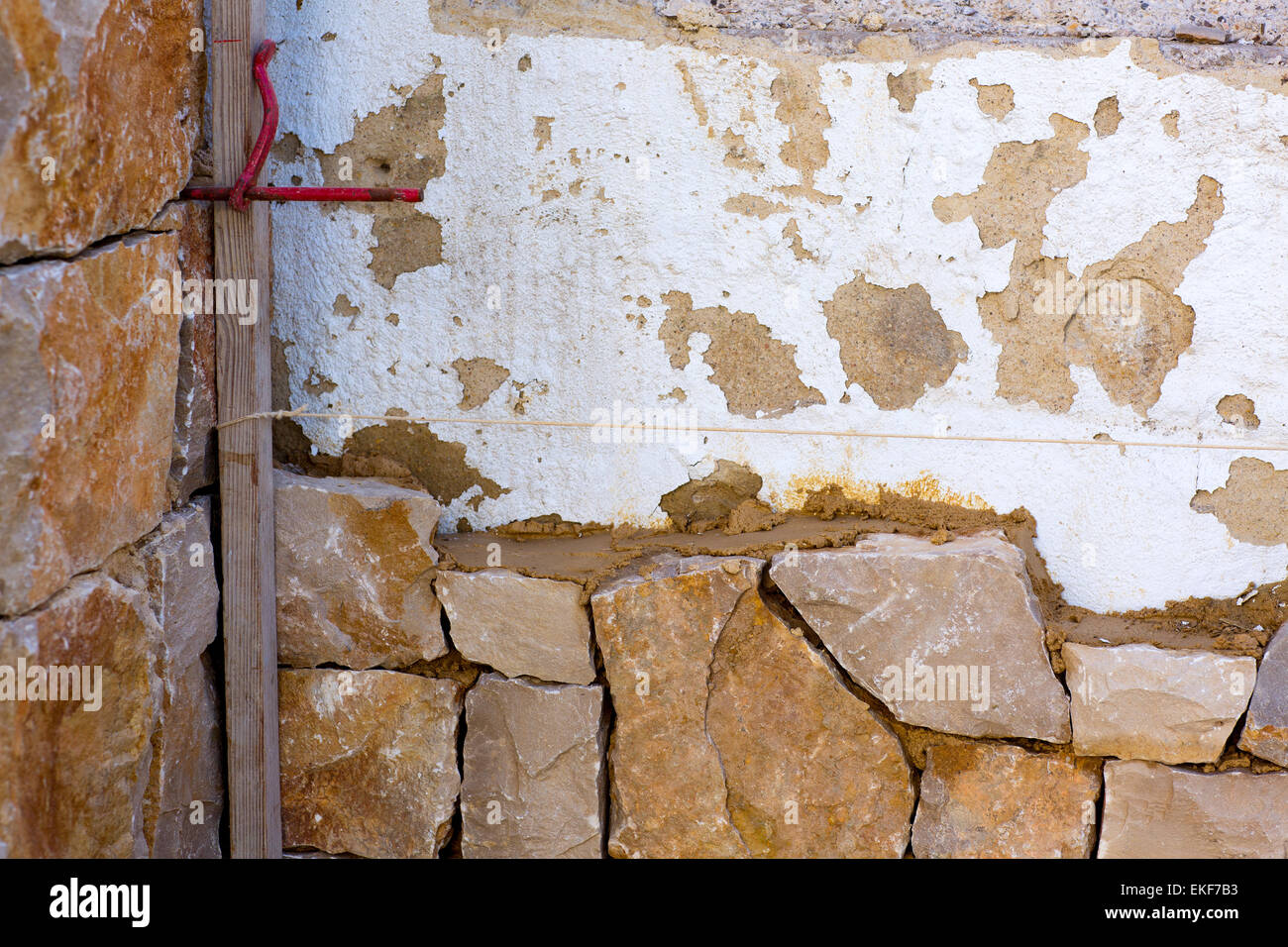Masonry stone wall construcion process traditional Stock Photo - Alamy