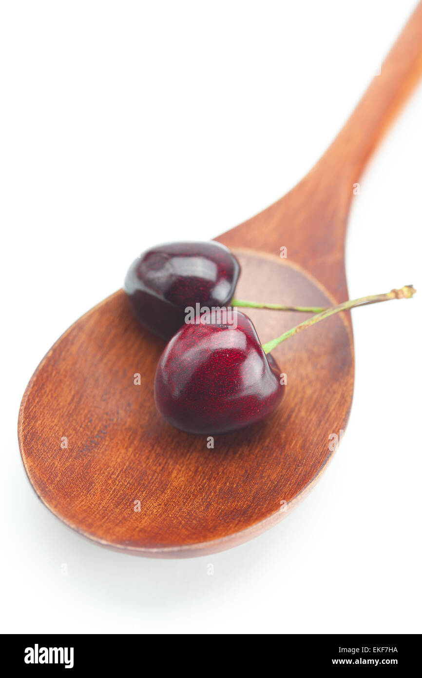 wooden spoon and cherry isolated on white Stock Photo - Alamy