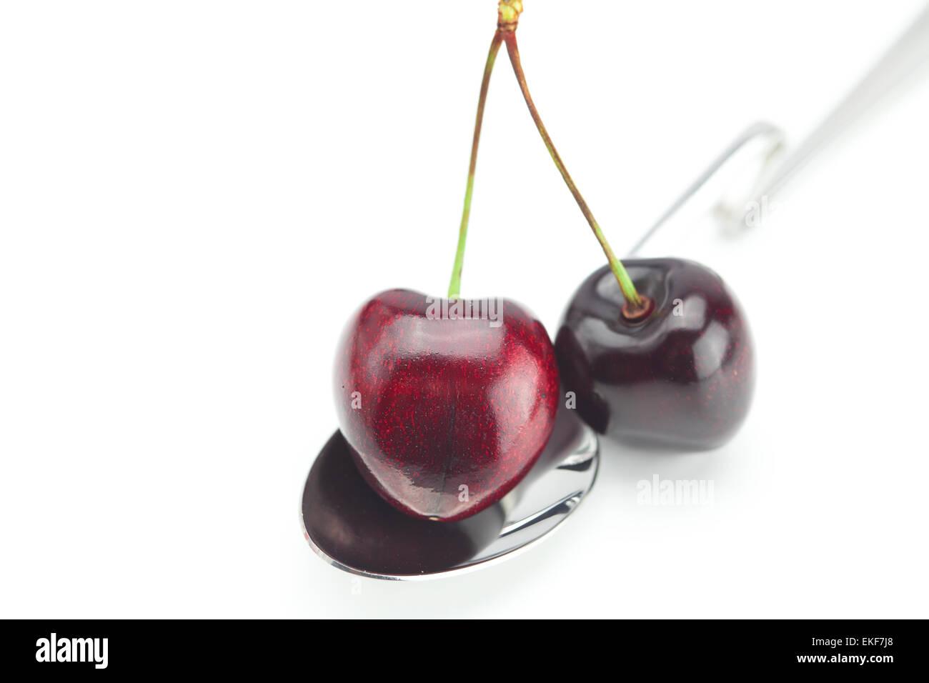 spoon and cherry isolated on white Stock Photo - Alamy