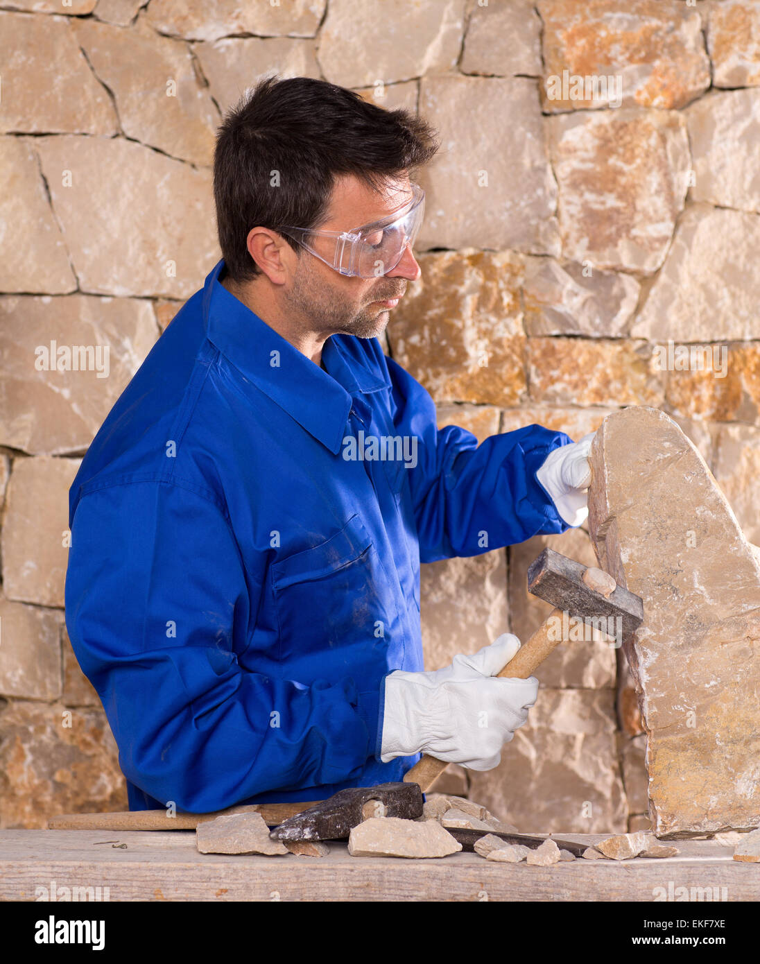 Masonry mason stonecutter man with hammer working Stock Photo - Alamy