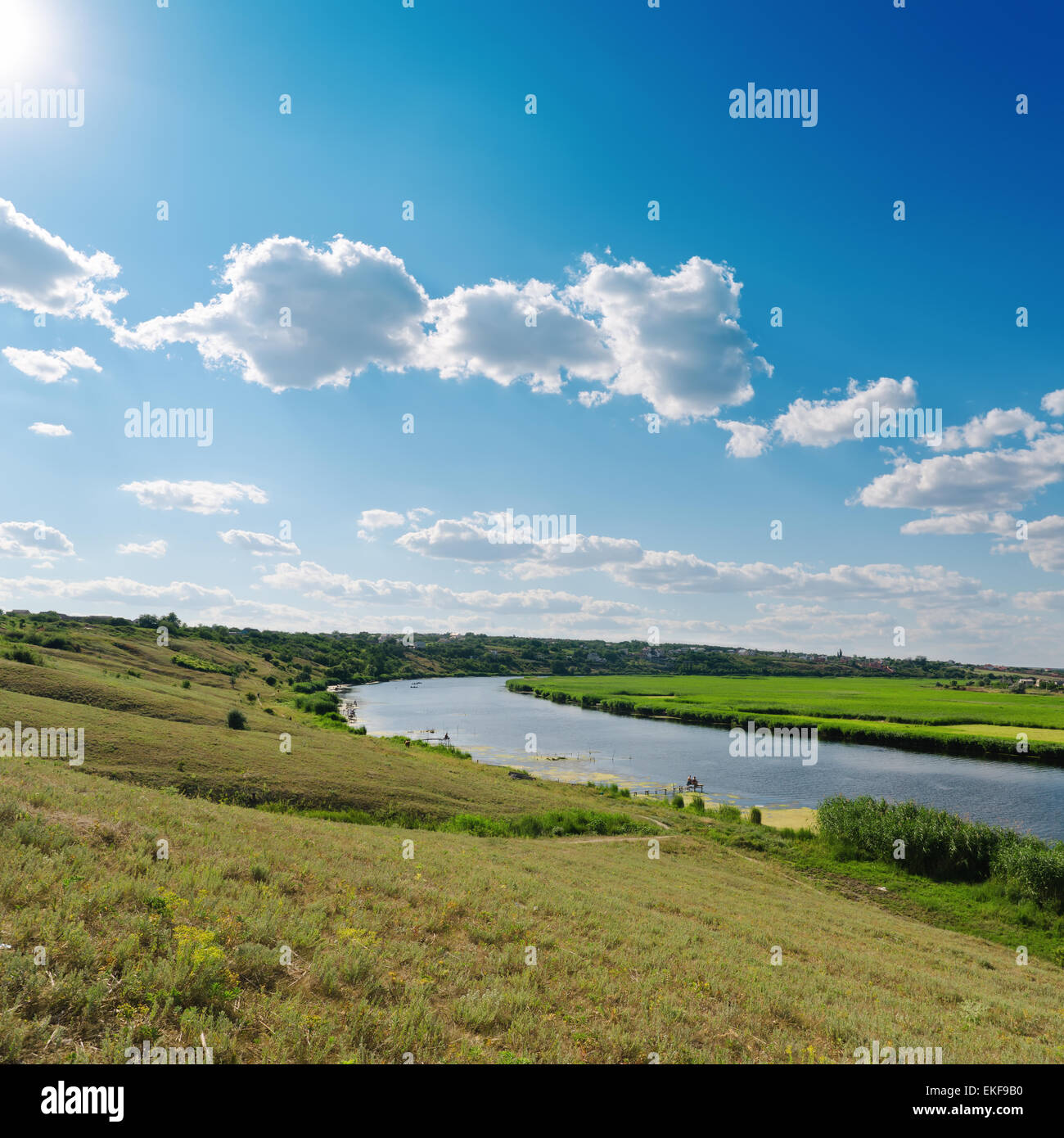 cloudy sky with sun over river Stock Photo - Alamy