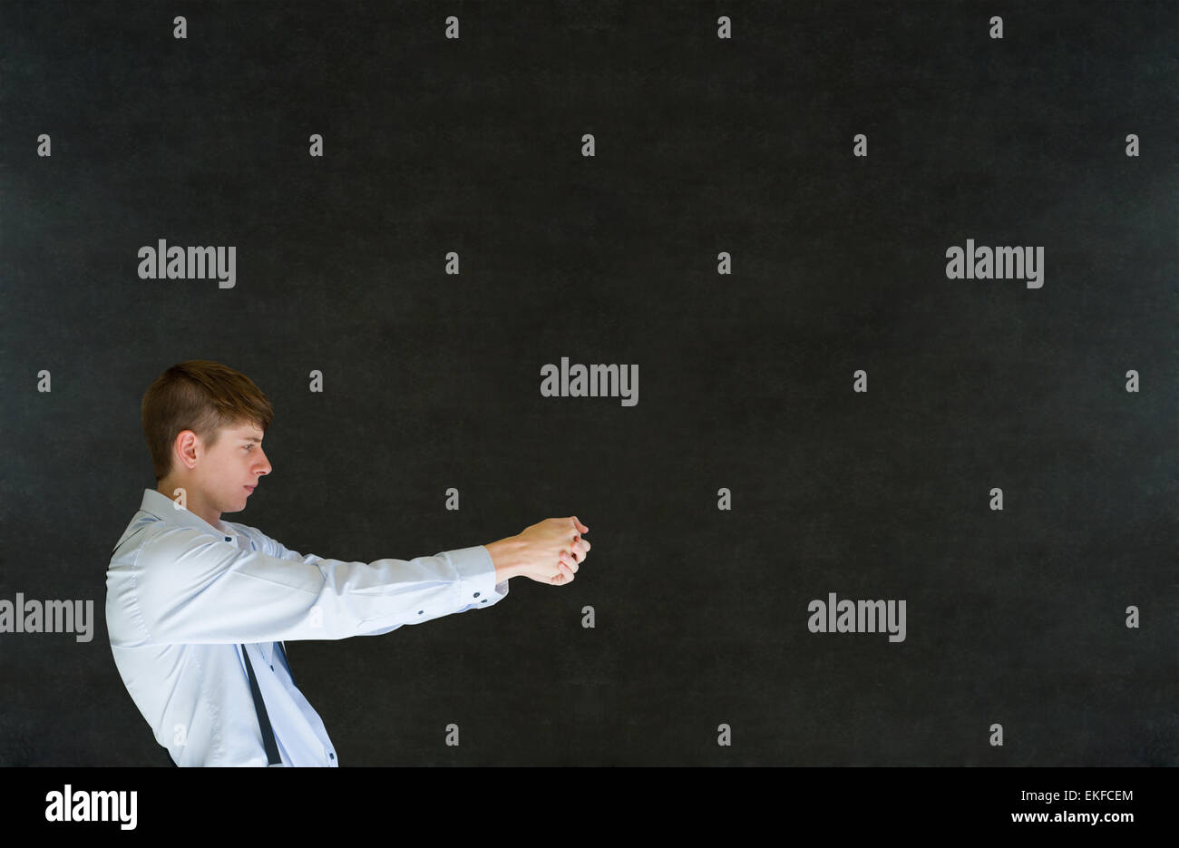 Man pulling on blackboard background Stock Photo - Alamy