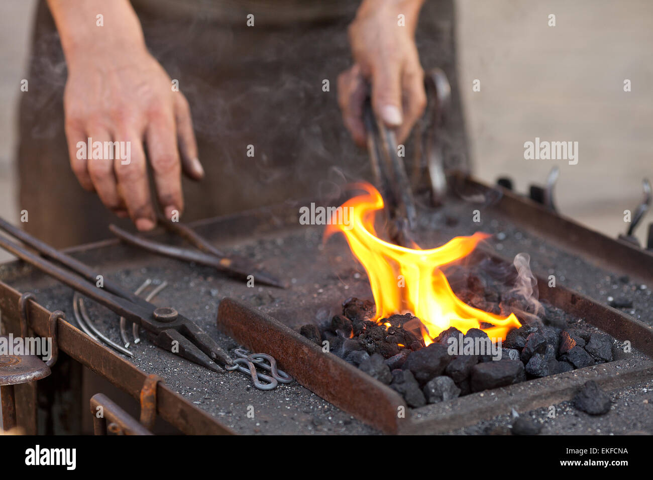 embers, fire, smoke, tools and the hands of a blacksmith Stock Photo ...